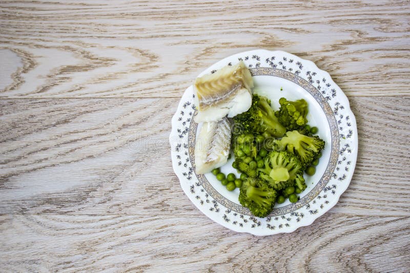 Boiled White Fish, Broccoli and Green Peas in a Plate on an Empty ...