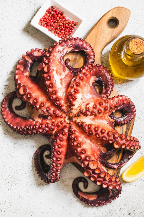 Boiled Whole Octopus on a Gray Stone with Lemon and Pink Pepper Stock ...