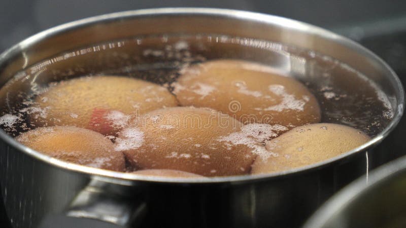 Boiling Eggs in a Stainless Steel Pot with Bubbling Water on the Stove ...