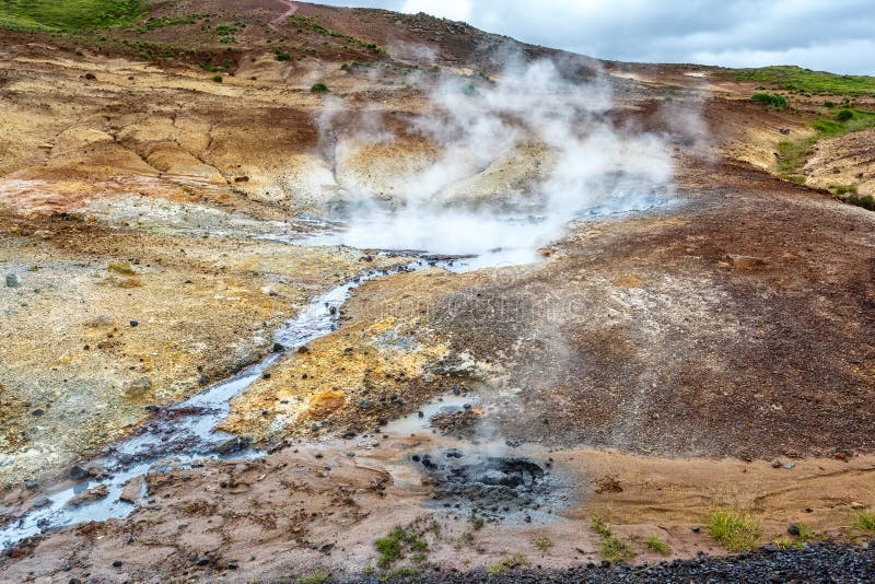 Boiling Hot Spring in Iceland on the Background of Colorful Mountains ...