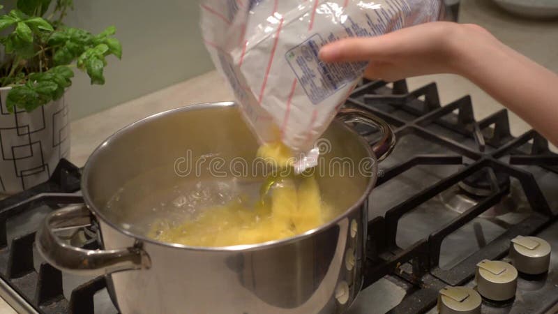 Boiling Pasta in the Metallic Pot and a Scissor Cutting it and Mixing ...