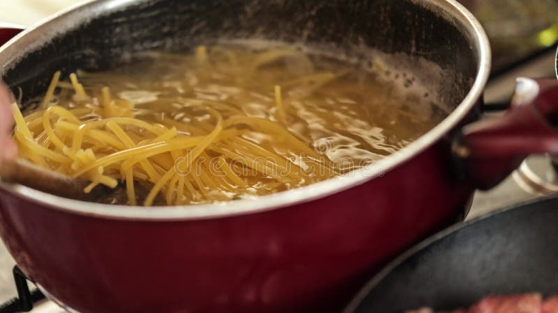 Boiling pasta at home stock footage. Video of gourmet - 287665114