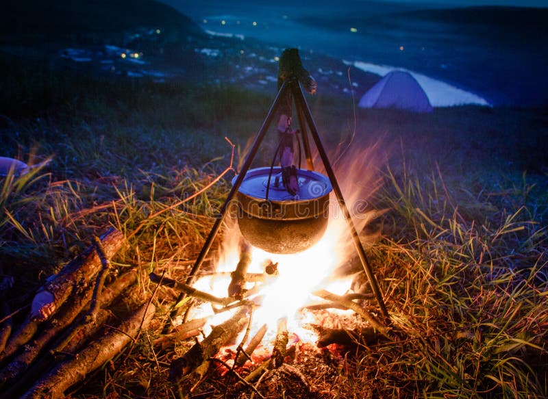 Boiling Pot at the Campfire on Picnic after Sunset. Stock Image - Image ...