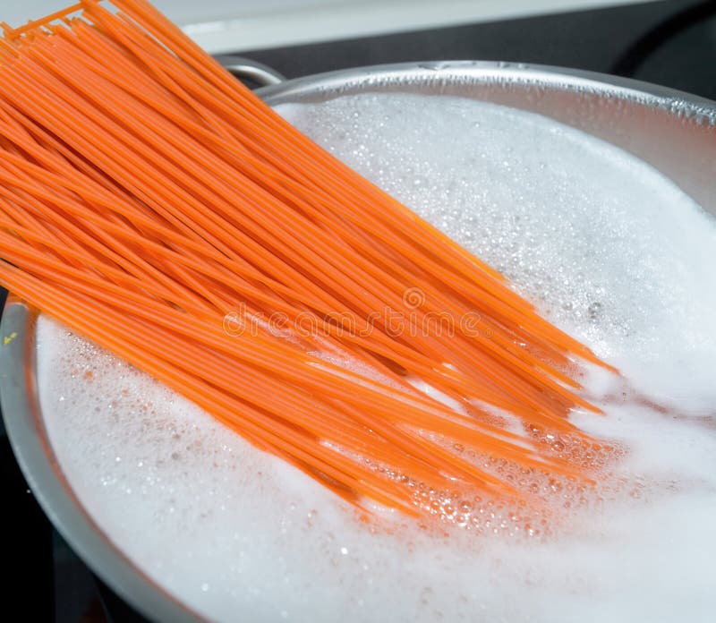Boiling red past in water stock image. Image of glass - 232518977