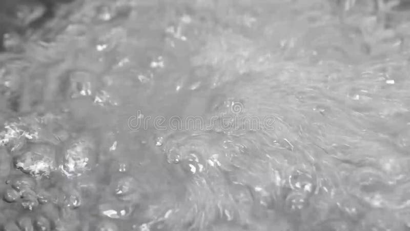 Boiling Water with Macro Bubbles Close-up on Black Kitchen Stove for ...