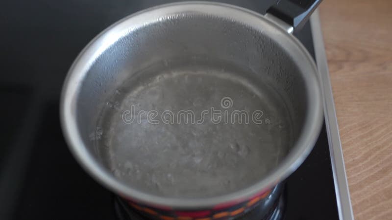 Boiling water in saucepan stock footage. Video of energy - 311748120