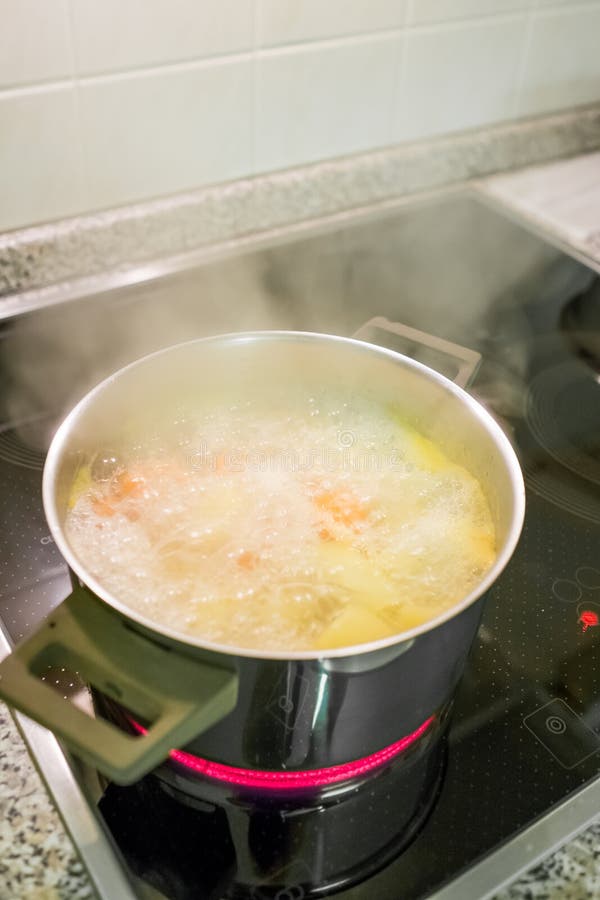 Boiling Water in a Saucepan Stock Photo - Image of potatoes, vertical ...
