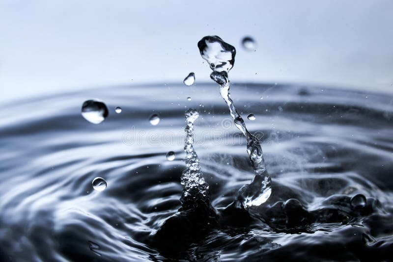 Boiling Water Splash with Steam on Blue Background Closeup Stock Photo ...