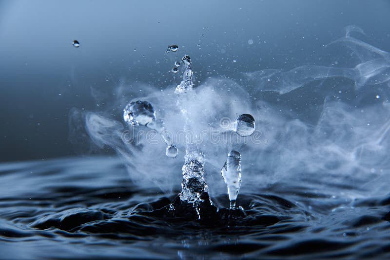 Boiling Water Splash with Steam on Dark Blue Background Closeup Stock ...