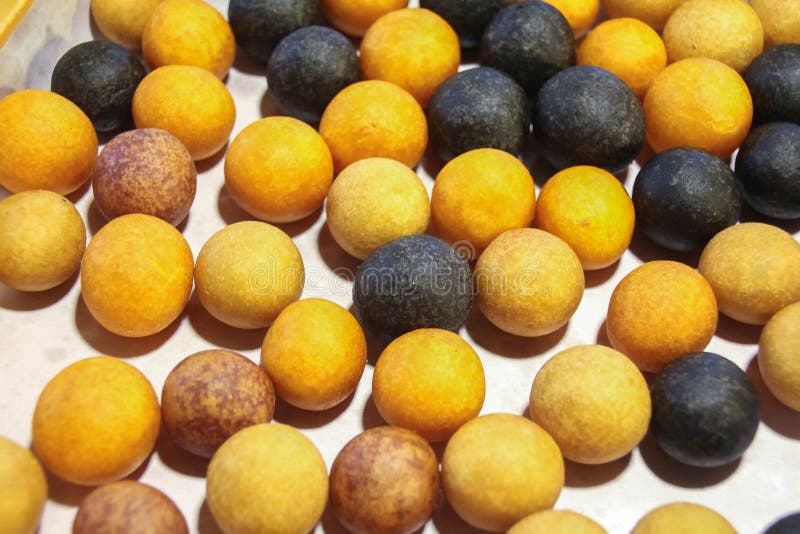 Round or Circular Sweets are Black and Orange and Yellow and Brown ...