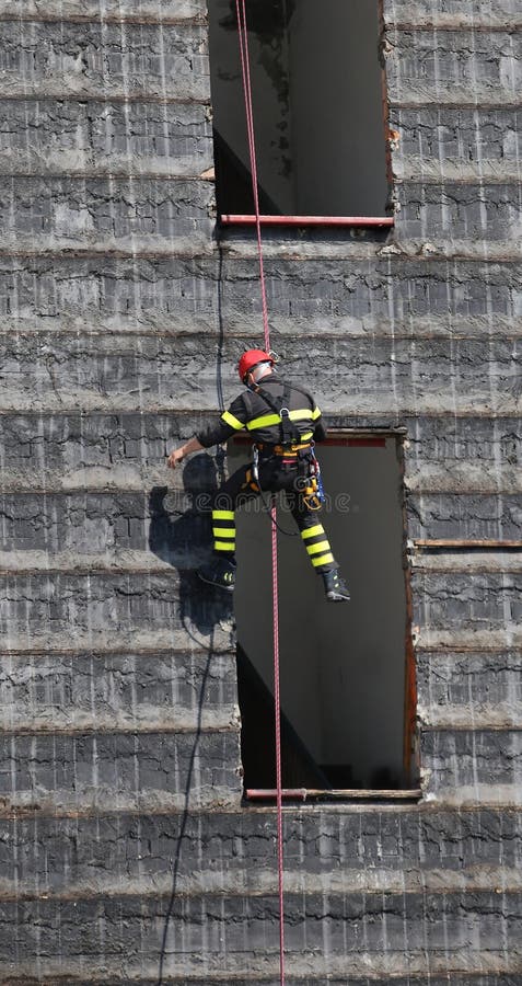 Climber of Firefighter Climbing a Wall of a House Editorial Stock Image ...