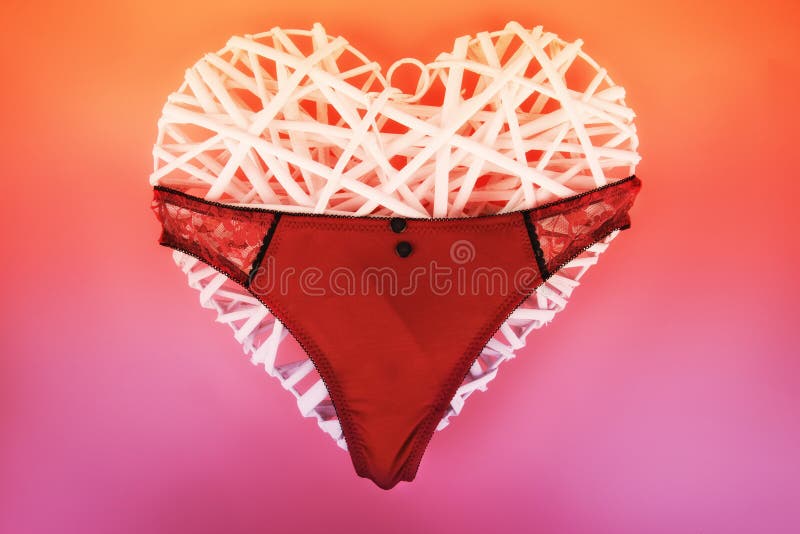 Bold and Romantic Composition Featuring Red Lace Lingerie Draped Over a ...