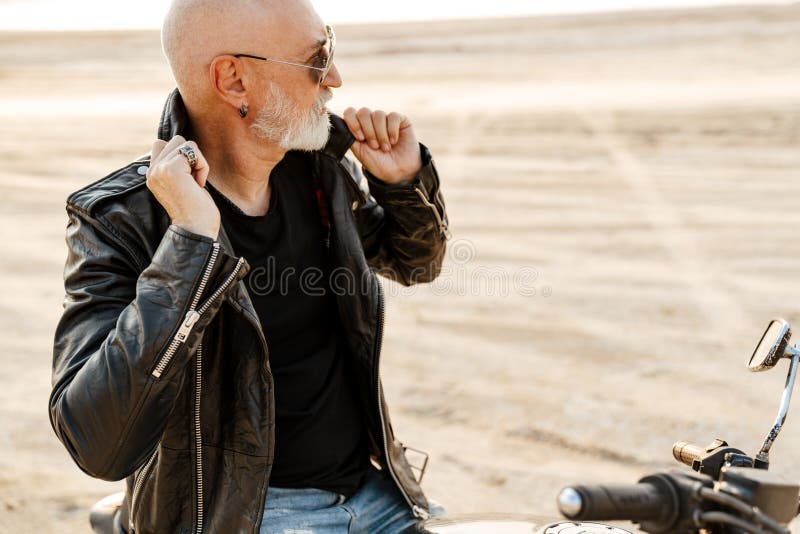 Bold Senior Man Wearing Leather Jacket Posing on Motorcycle Outdoors ...