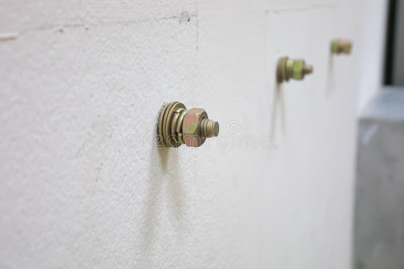 Bolt and nut on wall. stock photo. Image of object, construct - 84785800