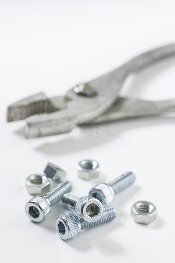 Bolts, nuts and a plyer stock photo. Image of carpenter - 80113936