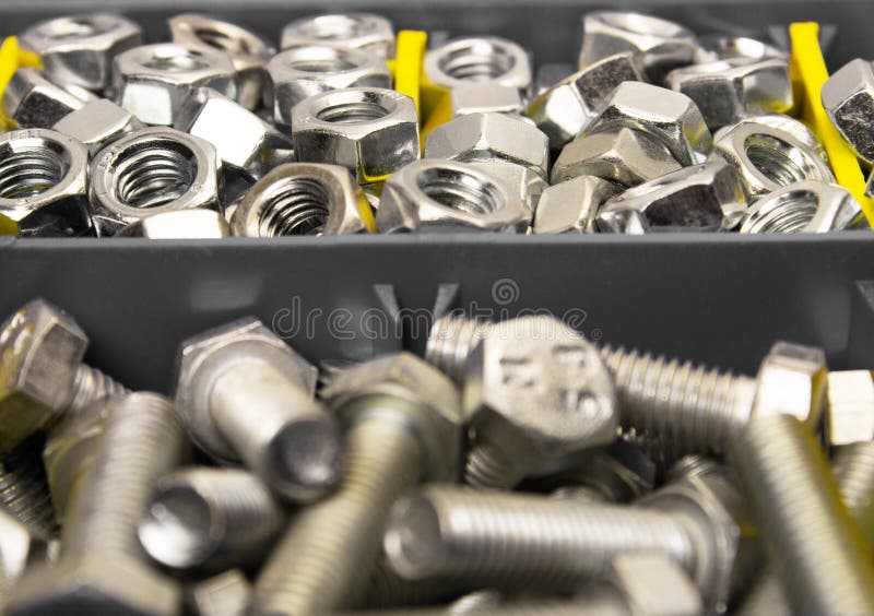 Bolts and Nuts Sorted in Container with Gray and Yellow Partitions ...