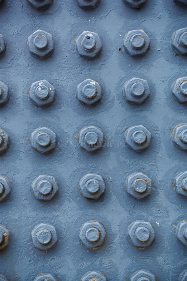 Bolts and nuts on the wall stock photo. Image of together - 77850138