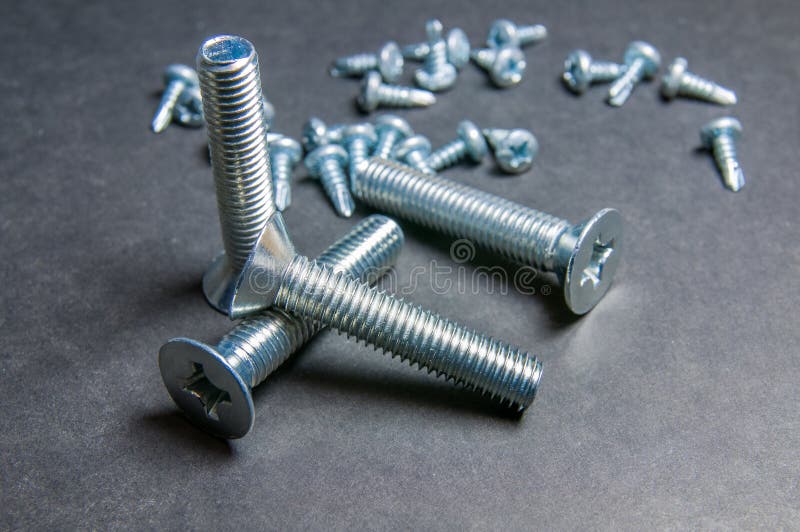 Bolts and Screws on Grey. Left Upright Bolt (right Light) Stock Photo ...