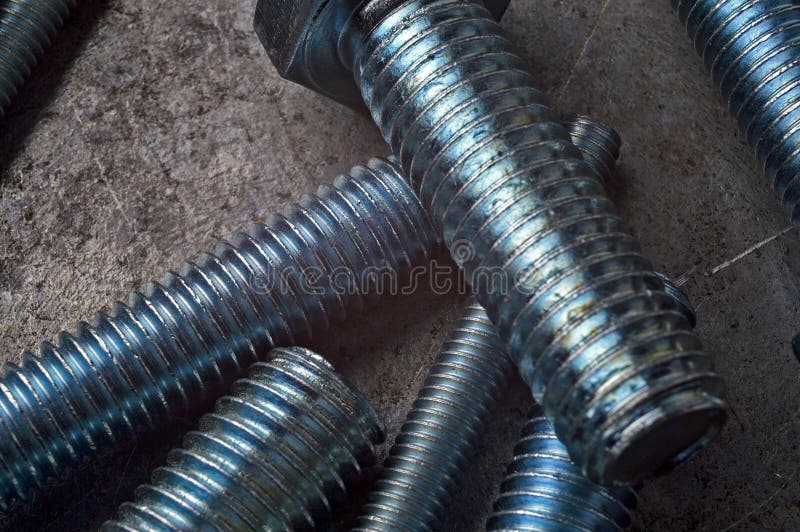 Bolts of Various Sizes Laid Out on a Metal Surface. Assorted Closeups ...