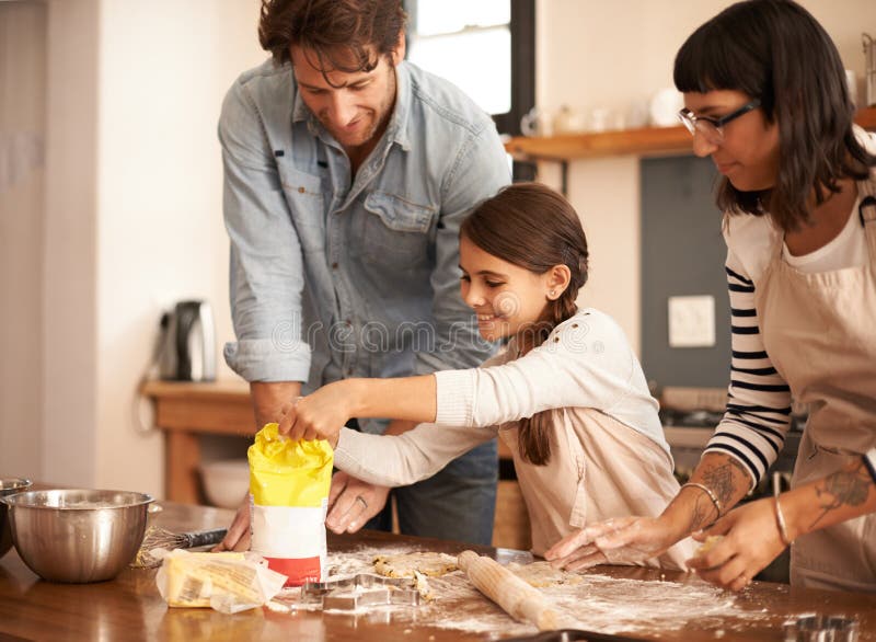 Bonding while Baking. a Family Having Fun Baking in a Kitchen. Stock ...
