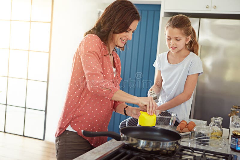 Bonding while Baking. a Mother Baking with Her Daughter in the Kitchen ...
