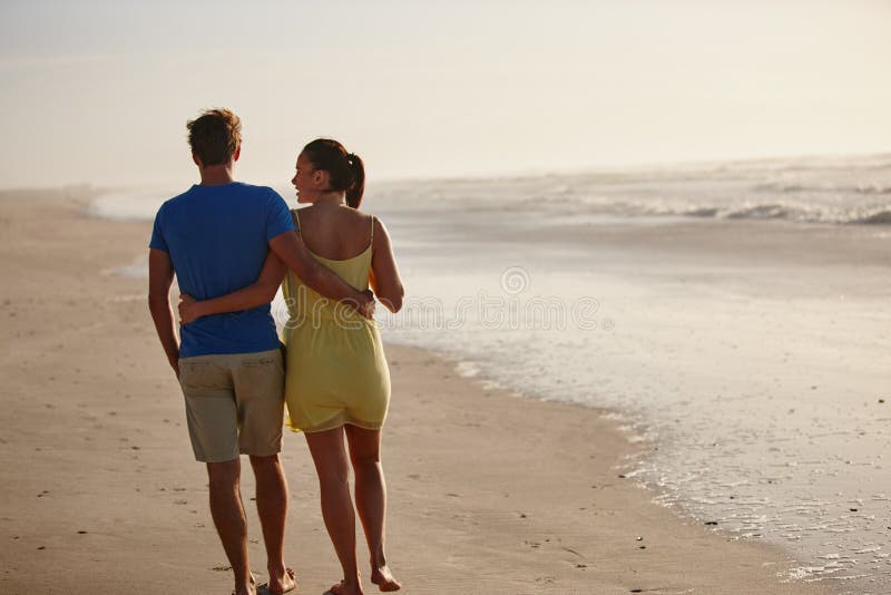 Bonding on the Beach. an Affectionate Couple Walking on the Beach ...