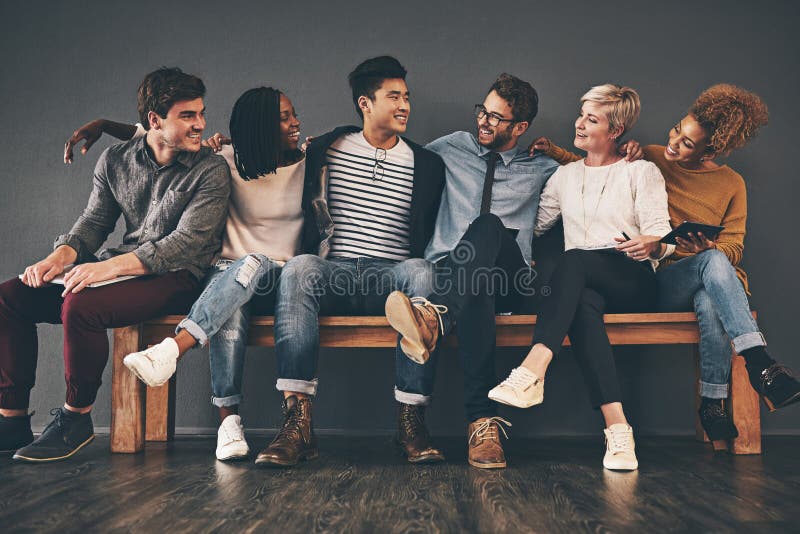 Bonding on the Bench. Studio Shot of a Diverse Group of Creative ...