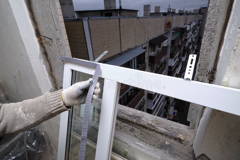 Bonding Insulating Tape To a Plastic Window during Installation Stock ...