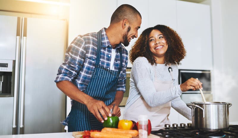 Bonding Over Cooking. a Young Couple Cooking Together at Home. Stock ...