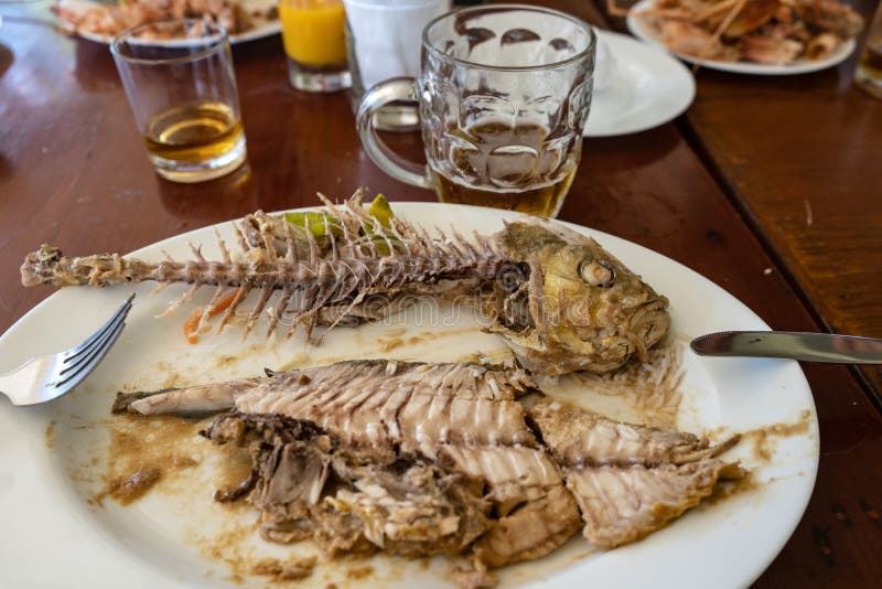 Bones of Eaten Fish on a Table in a Restaurant Stock Photo - Image of ...