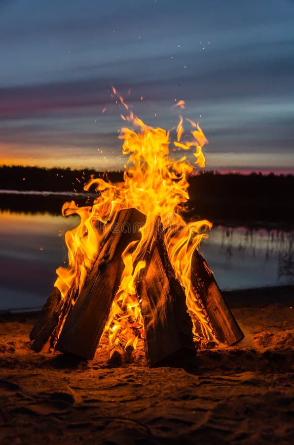 Bonfire on the beach sand stock photo. Image of evening - 54532894