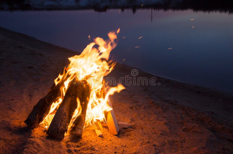 Bonfire on the beach sand stock photo. Image of evening - 54533466