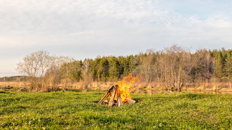 A Bonfire in the Field Near the River Stock Photo - Image of camp ...