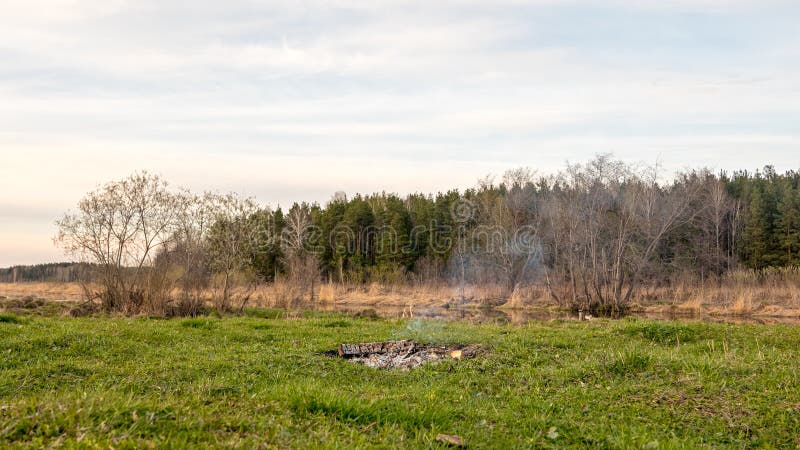 A Bonfire in the Field Near the River Stock Photo - Image of field ...