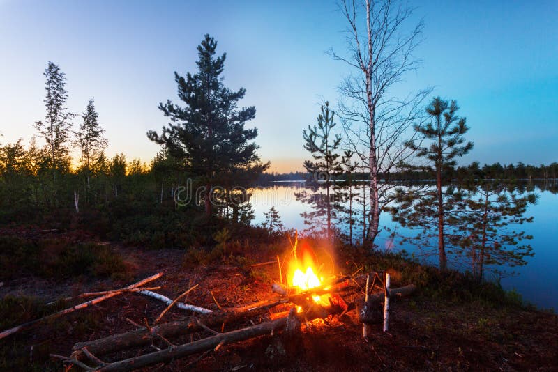 Bonfire is Near the Lake at Sunrise Stock Photo - Image of spinning ...