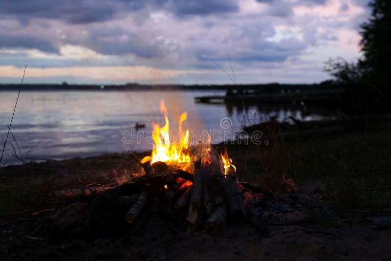 Bonfire on the Shore of the Lake at Sunset Stock Photo - Image of beach ...