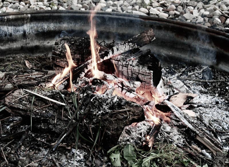 Bonfire stock photo. Image of smoldering, rocks, logs - 191565852