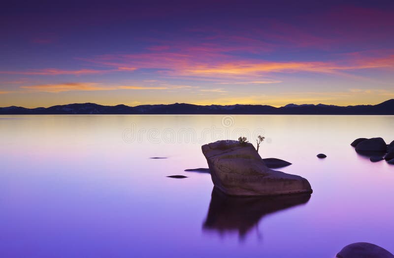 Mountain Lake Driftwood Sunset with Water and Sky Stock Image - Image ...