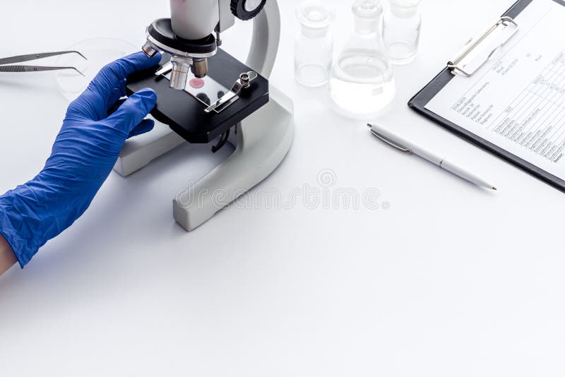 Bood Testing with Microscope in Laboratory. Equipment on White ...