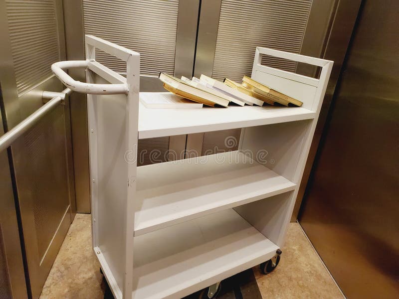 Book cart in elevator stock photo. Image of floor, wood - 215529410
