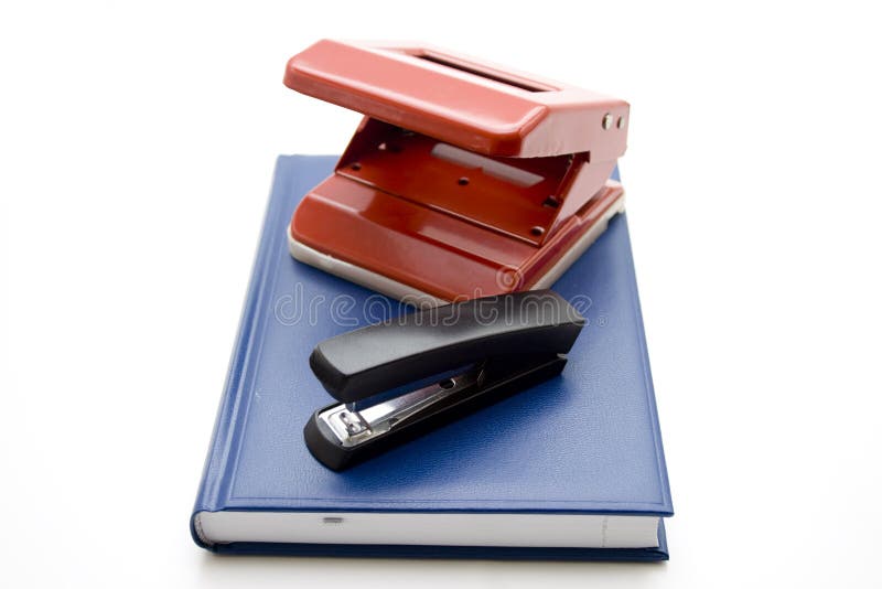 Book with file and punch stock image. Image of sides - 24111395