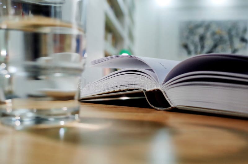 Book and glass cup stock image. Image of paper, glass - 60626741