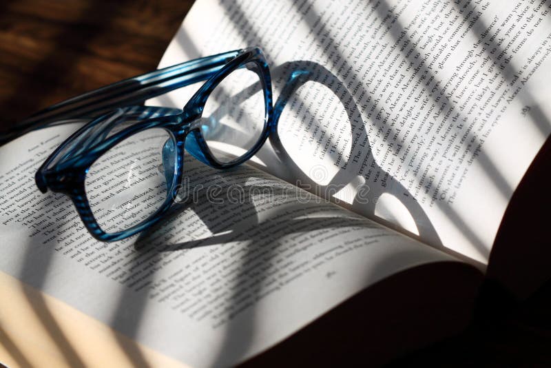 Book glasses reflection B stock image. Image of paperback - 39922149
