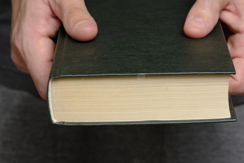 Book in Hand Gray Background. International Book Giving Day. Stock ...
