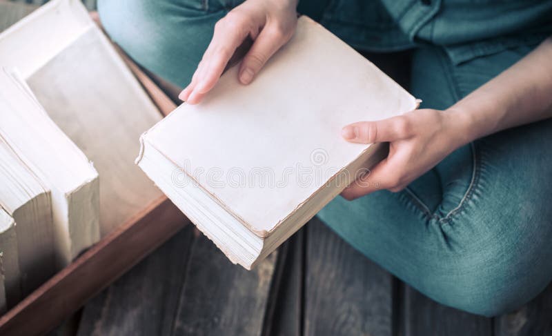 Book in hand stock image. Image of female, hardcover - 114997449