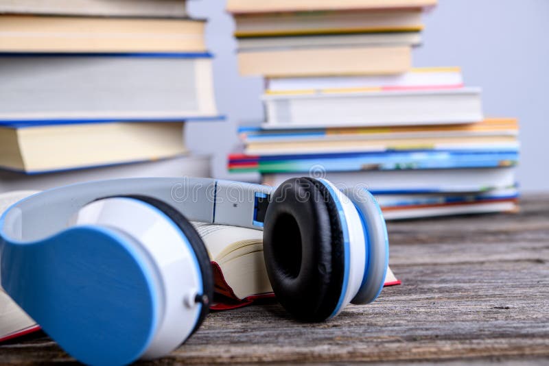 Book with Headphone in Front of Piles of Different Books Stock Photo ...