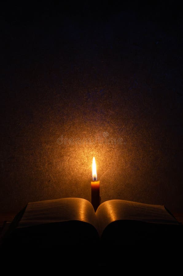 Book Illuminated by a Burning Candle on a Table Stock Photo - Image of ...