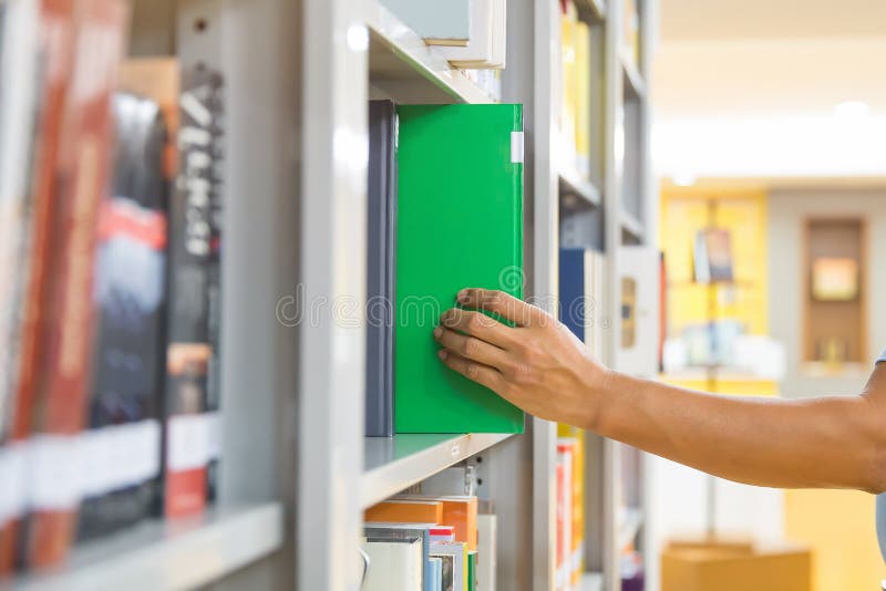 Close Up Hand Choosing and Picking Books from Bookshelf in Library ...