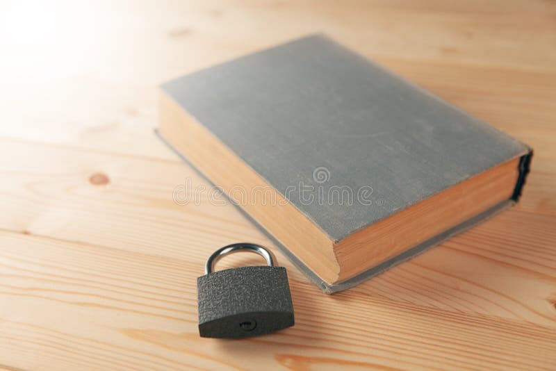 Book and Lock on a Wooden Table Stock Image - Image of secure, secret ...