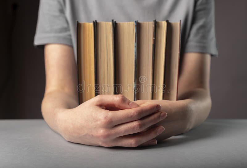 Book Lover Holding Horizontal Stack of Books in Hands, Reader Stock ...